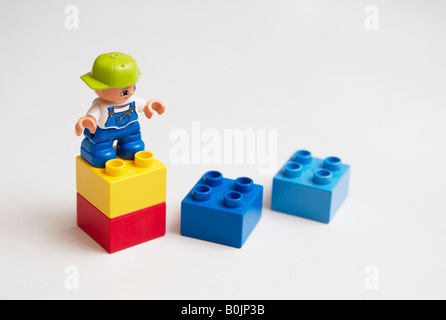 Lego Duplo blocks and Lego man against white background Stock Photo - Alamy