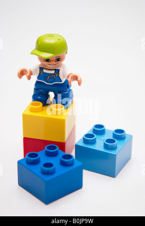Lego Duplo blocks and Lego man against white background Stock Photo - Alamy