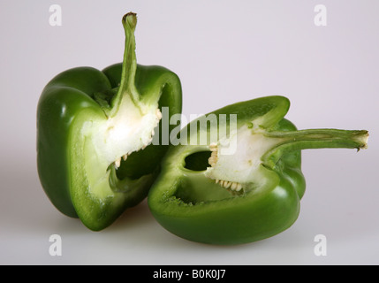 Green bell pepper sliced in half showing seeds and pith Stock Photo - Alamy