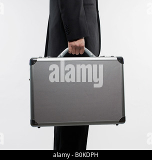 Midsection of businessman carrying briefcase on street Stock Photo - Alamy
