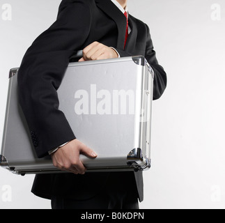 businessman grabs briefcase Stock Photo - Alamy
