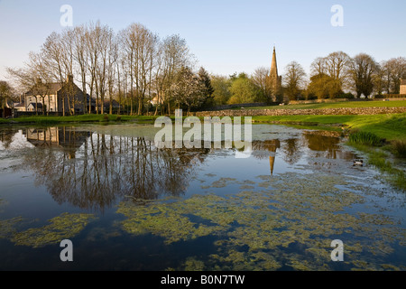 A typical English village duck pond on the green in Biddestone ...