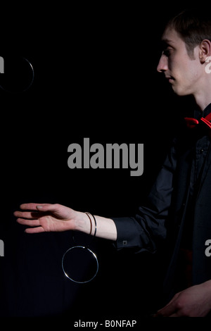 young magician performing trick with a hoop Stock Photo - Alamy