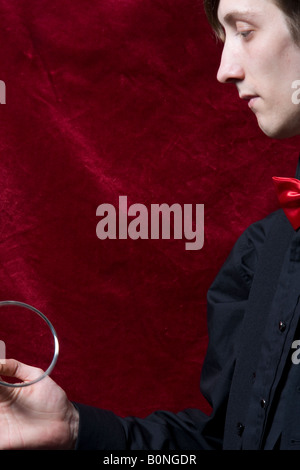 young magician performing trick with a hoop Stock Photo - Alamy