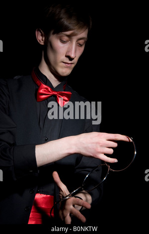 young magician performing trick with a hoop Stock Photo - Alamy