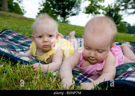 Babies playing outside Stock Photo - Alamy