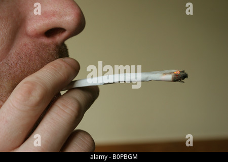 A cannabis spliff cigarette or joint being smoked, Amsterdam, Holland ...
