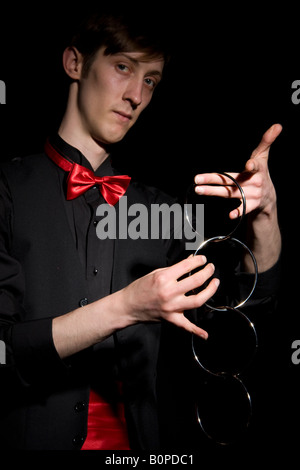 young magician performing trick with a hoop Stock Photo - Alamy