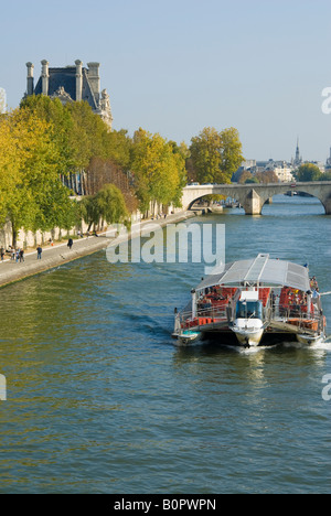 A pleasure boat cruises along the Seine in Paris with the Eiffel tower ...
