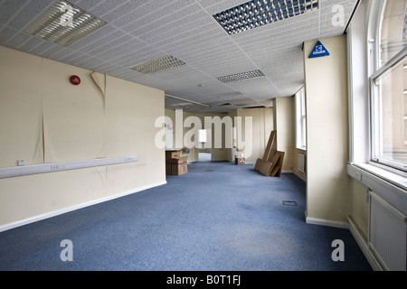 Empty, abandoned office with ceiling tiles and a grey carpet Stock ...