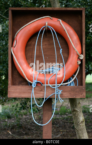 Life saving ring with rope by waters edge on harbour quayside Stock ...