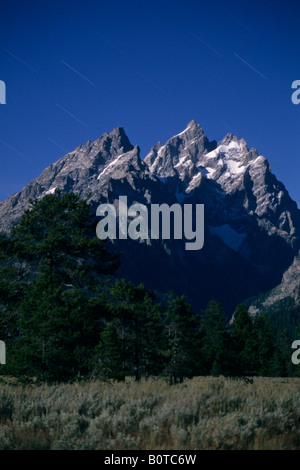 Star streaks at night over the Grand Tetons by light of full moon Grand ...