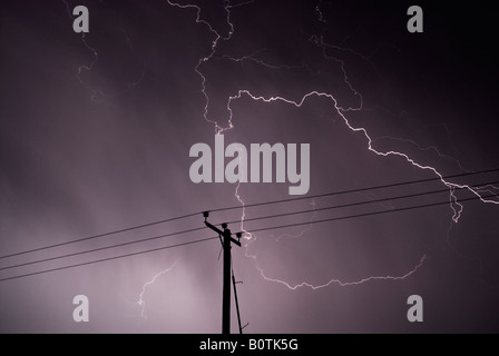 An electricity pylon and a flash of lightning Stock Photo - Alamy
