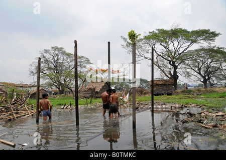 Cyclone Nargis survivors rebuild their flooded house in Hlaing Tharyar ...