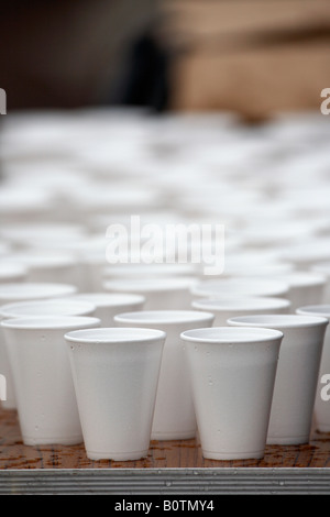 polystyrene styrofoam cups full of water sitting on a table during a ...