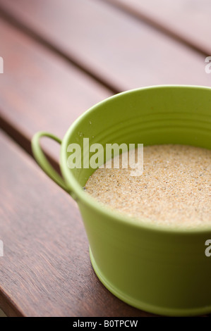 Decorative ashtray filled with sand on a patio table Stock Photo - Alamy