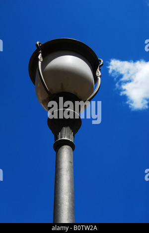 A vertical shot of street lamp post with trees in the background Stock ...