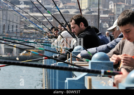 Fishermen angle at the Galata bridge during a hot day in Istanbul ...