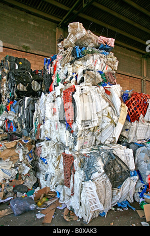 Bales of compacted plastic waste stacked high at recycling center in ...