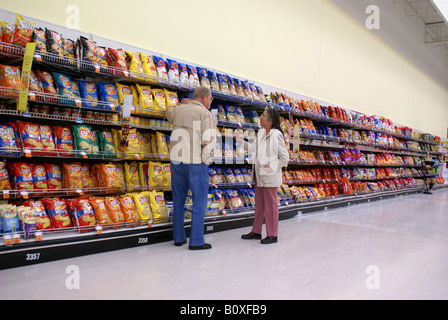 In supermarket man choose snacks Stock Photo - Alamy
