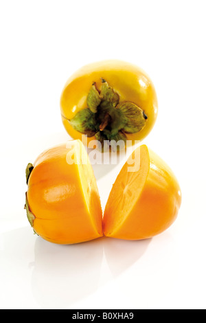 Kaki cut in half Stock Photo - Alamy