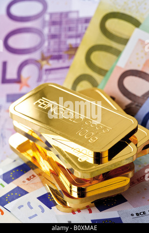 Gold bullions at euro banknotes closeup background. Gold bars lie on ...