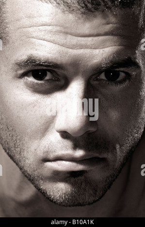 Dramatic moody close up portrait of angry young adult man with intense ...