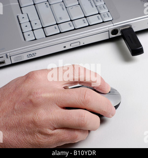 Laptop user with a mini usb wireless mouse Stock Photo - Alamy