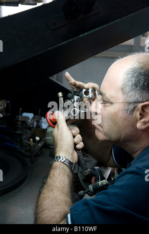 diamond cutting and polishing workshop worker inspecting the diamond ...