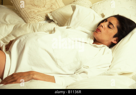 anglo-asian woman in labour receiving help and support from her partner ...
