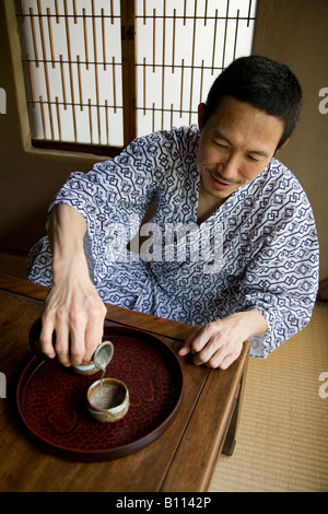 Pouring rice wine Stock Photo - Alamy