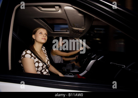 Two young women driving white Range Rover Sport Stock Photo - Alamy