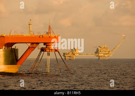 Flare of an FPSO oil rig in offshore area. Burning gas in Campos Stock ...