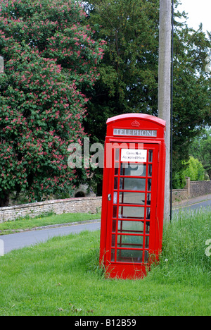 UK telephone box with no coins sign Stock Photo - Alamy