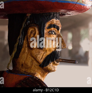 A carved, wooden smoking figure Stock Photo - Alamy