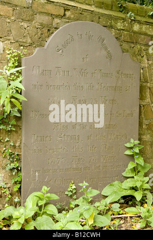 Overgrown headstone in church graveyard Stock Photo - Alamy