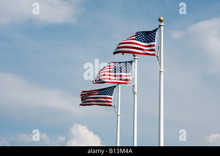 Waving three American flags in support the United States and freedom ...