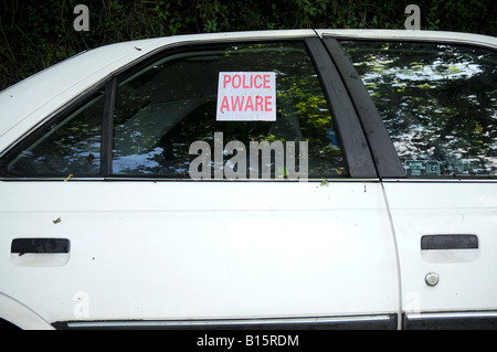 Peugeot 405 lying in a ditch with Police Aware sticker on side window ...