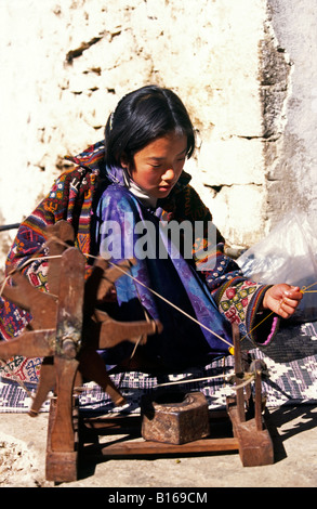 Bhutan Trongsa crafts girl spooling wool for weaving Stock Photo - Alamy