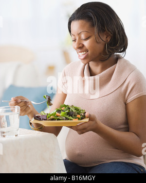 a young African American woman eating pasta Stock Photo - Alamy