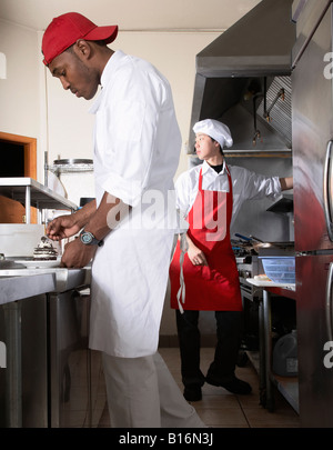 Multi-ethnic chefs cooking food at kitchen counter in restaurant Stock ...