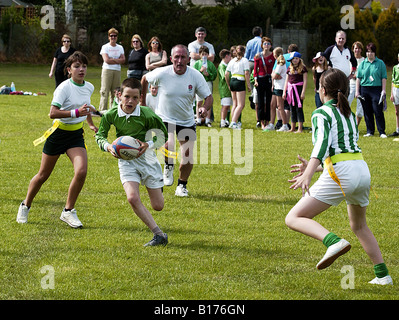 Teams of children playing tag rugby Stock Photo - Alamy