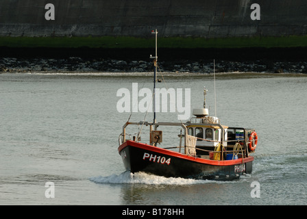 A fishing boat entering Aberystwyth harbour Stock Photo - Alamy