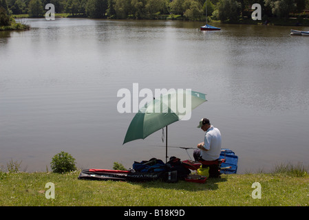 Fishing in the lake at with umbrella sunshade Goldsworth Park Woking ...