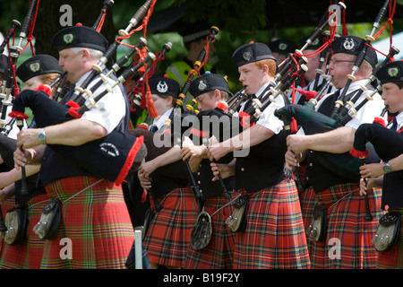 Scottish traditional music bag pipers pipe band marching down Annan ...