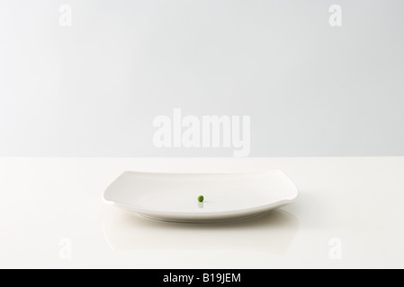 A single pea on a plate Stock Photo - Alamy