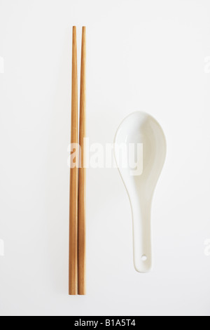Close-up of chopsticks and wooden spoon holding Korean steamed kimchi ...