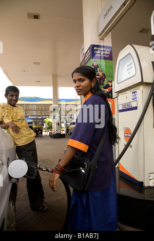 An Indian pump attendant is filling a car with gasoline at a Shell ...