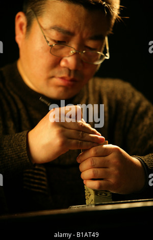 Chinese man carving chop Stock Photo - Alamy
