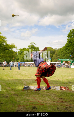 Scottish event, throwing a round metal ball chain stone shot, strongman ...
